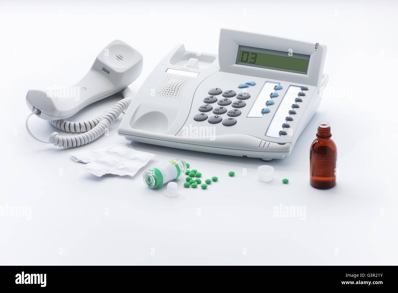 Telephone set and medicines in tablets or drops Stock Photo - Alamy
