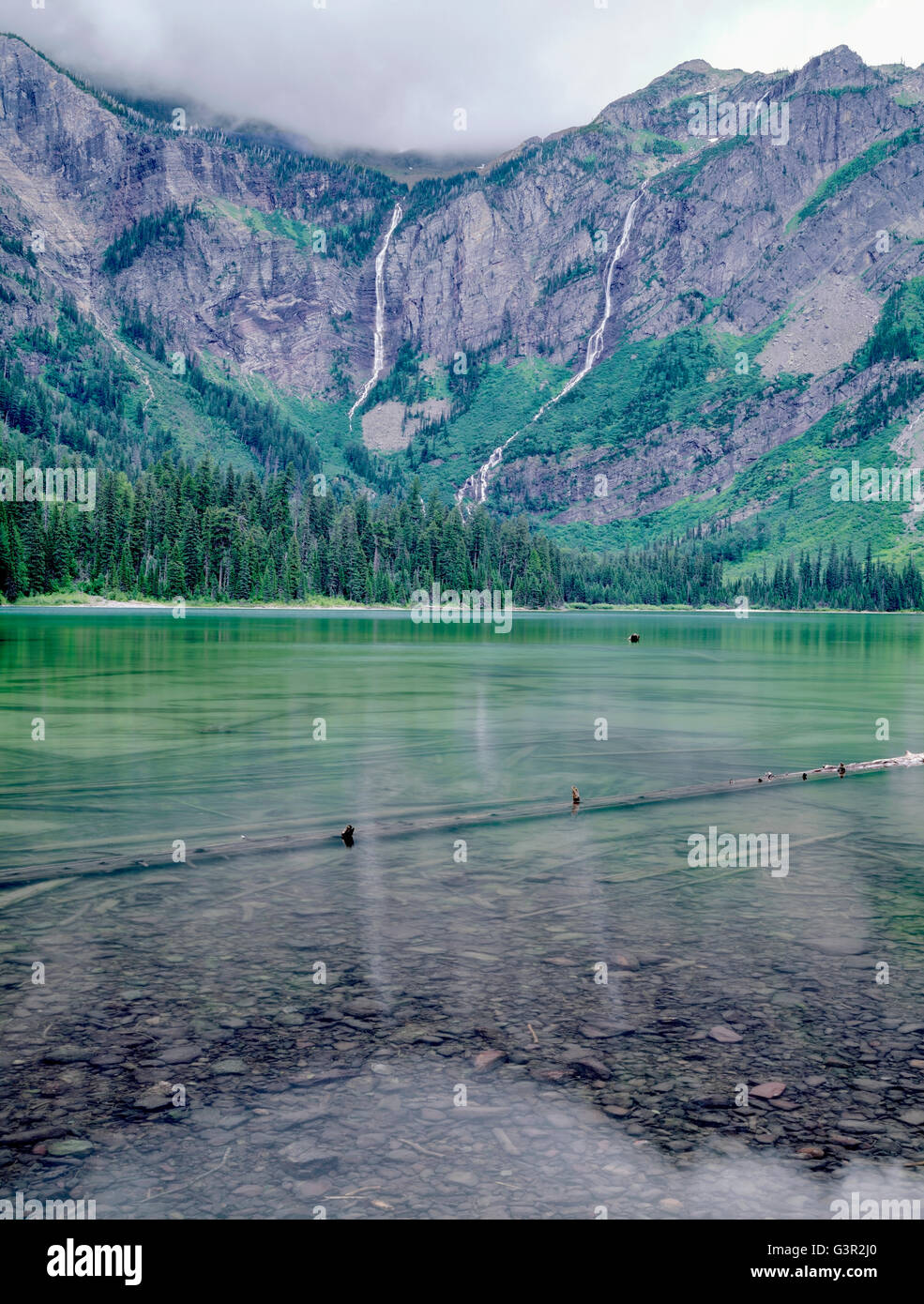USA, Montana, Glacier National Park, Waterfalls descend from high peaks ...