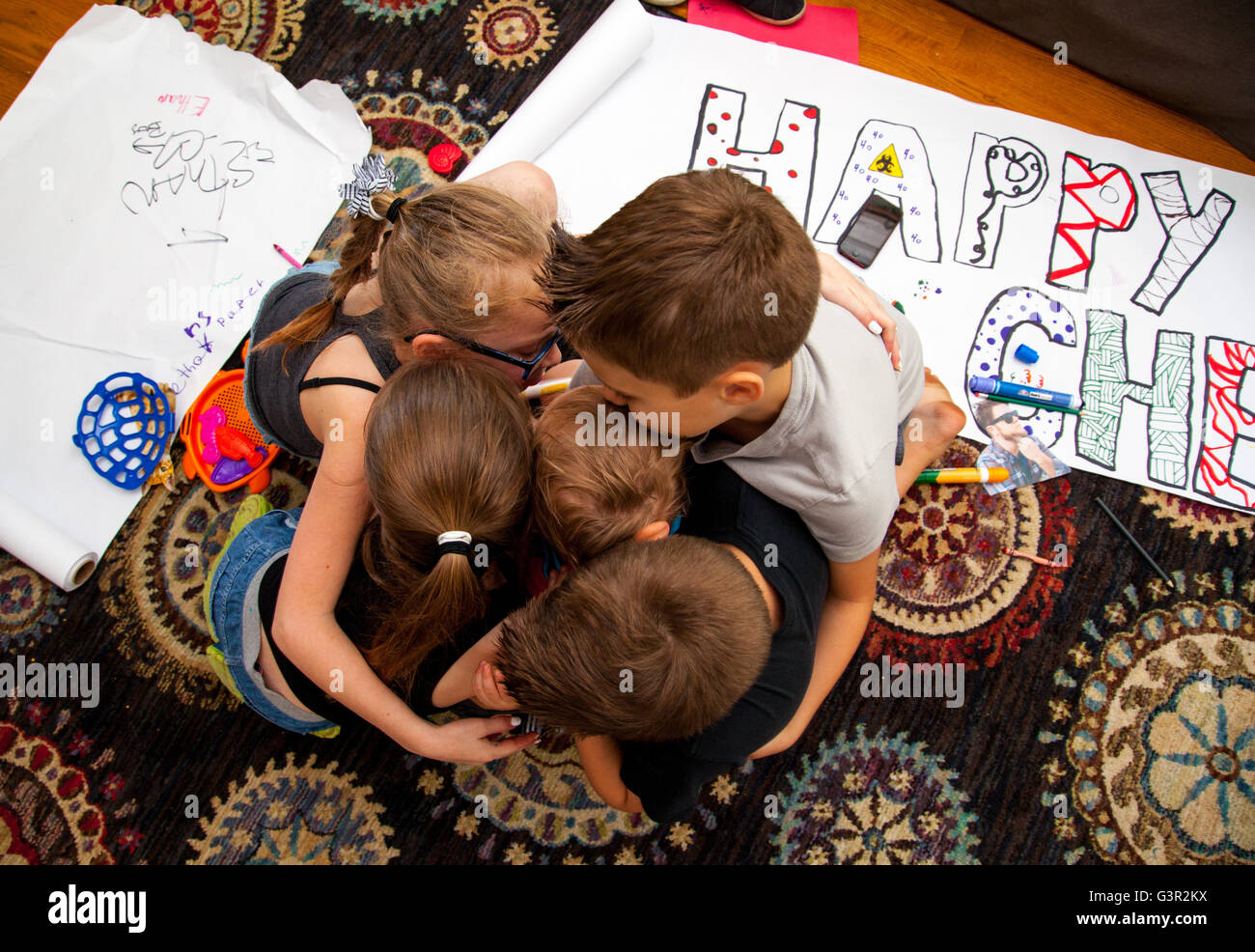 Four Caucasian Children Hug a Baby Boy on the floor of their Home Stock ...