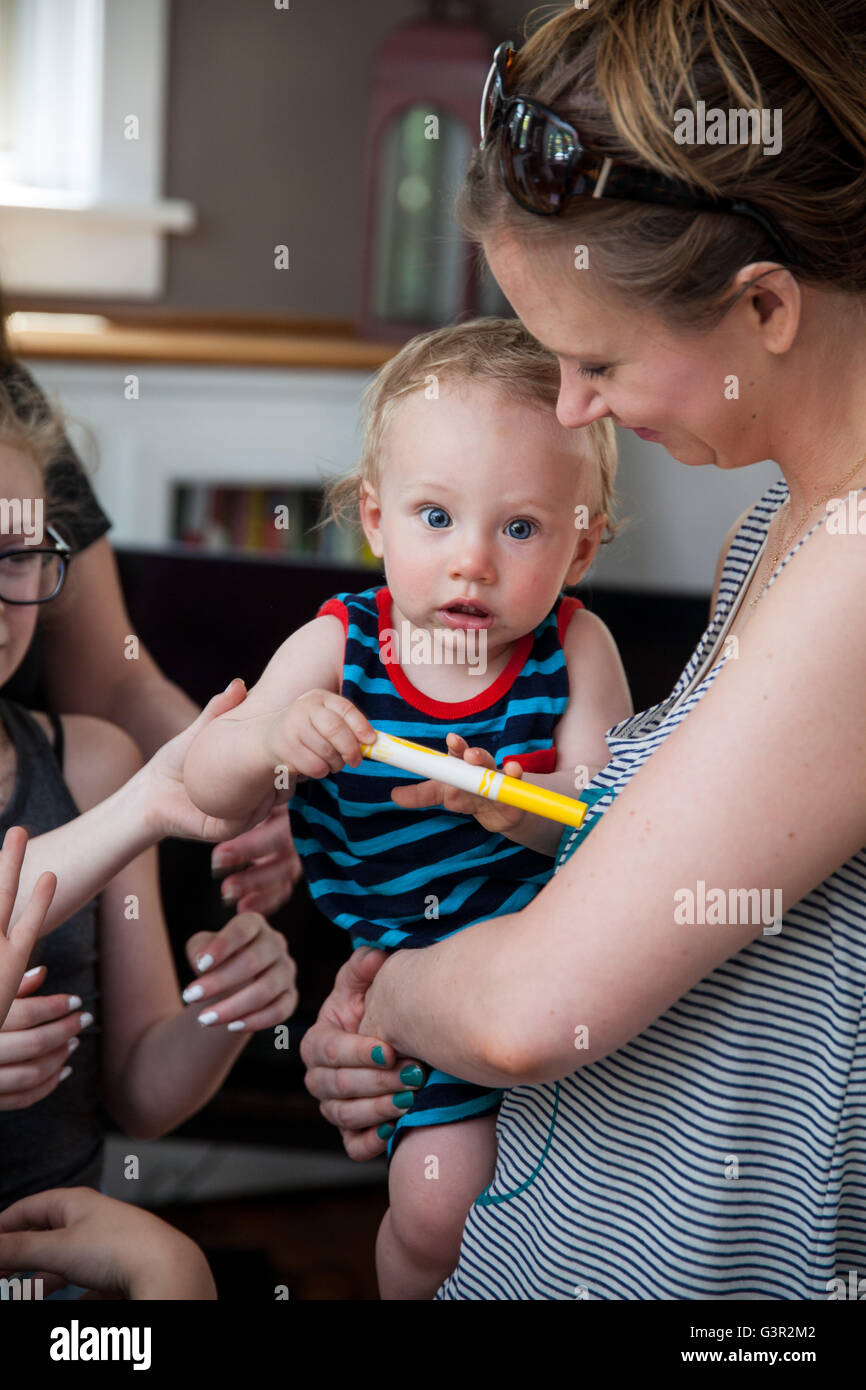 Young Caucasian boy celebrates first birthday with friends and family ...