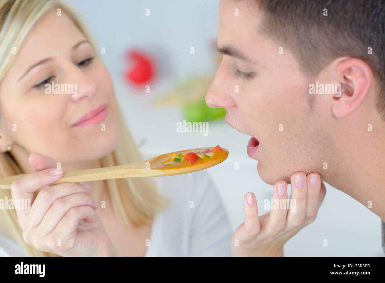 man tasting wife's dish Stock Photo - Alamy