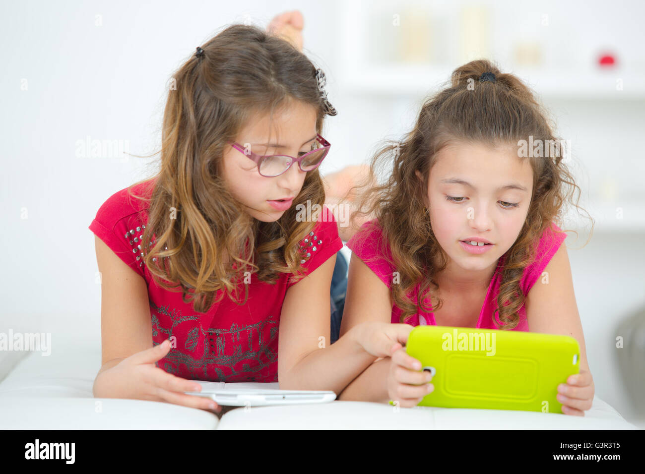 Little girls with tablet computers Stock Photo - Alamy