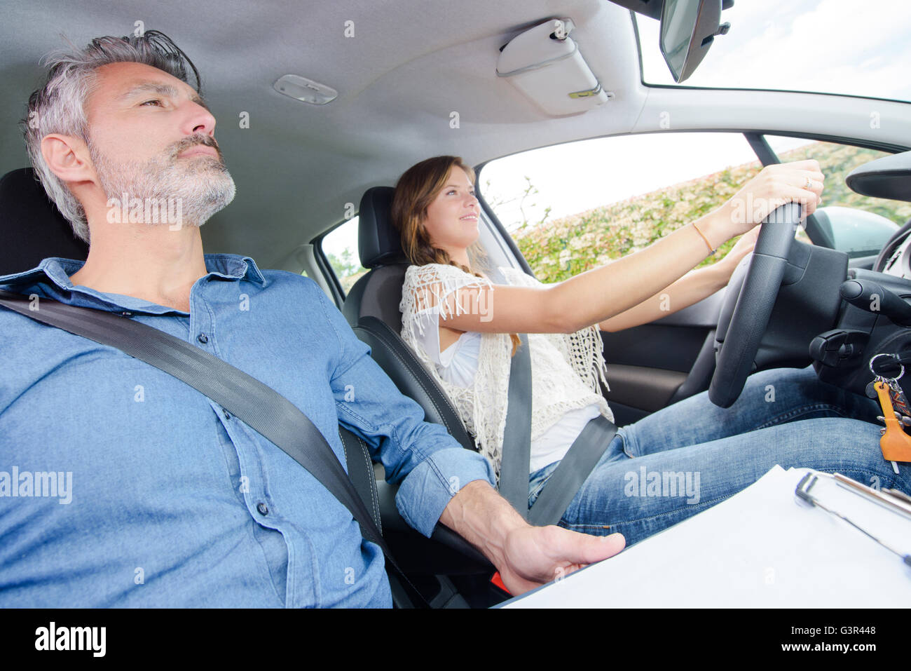 Driving instructor with female student Stock Photo - Alamy