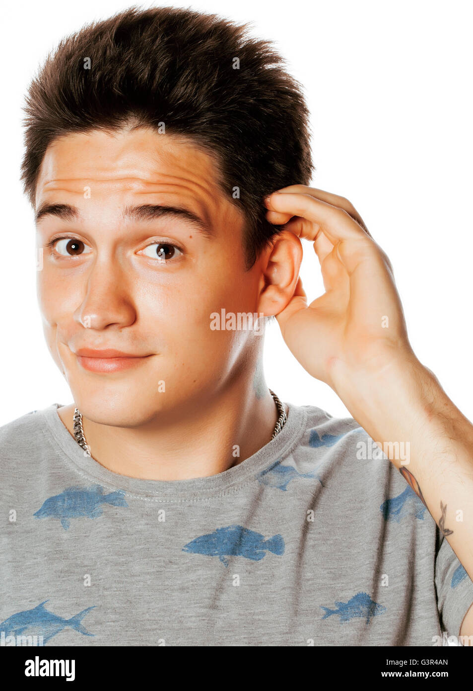 young pretty boy holding hand to ear, trying listen emotional isolated ...