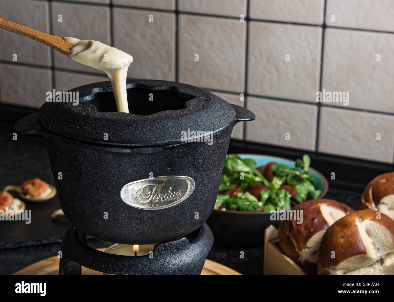 Cheese fondue preparation in kitchen Stock Photo - Alamy
