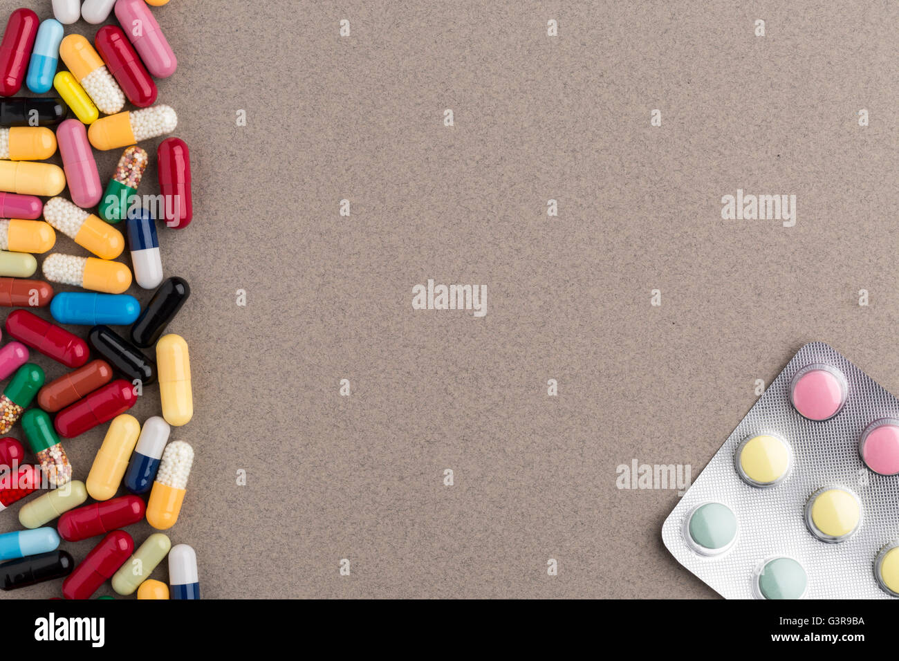 Various colorful capsules and pills on brown craft paper Stock Photo ...