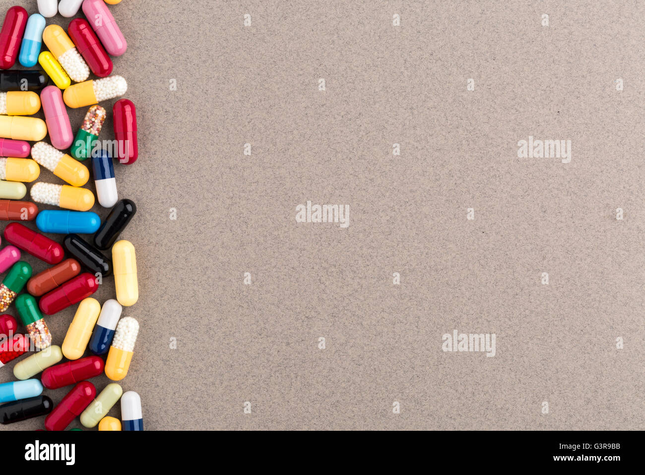 Various colorful capsules and pills on brown craft paper Stock Photo ...