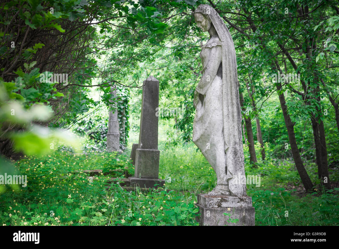 Woman statue grave, view of monuments in a forgotten corner of the Kerepesi Cemetery in the ...