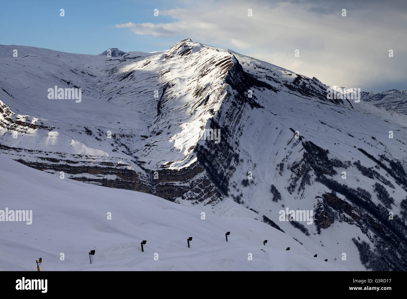 Ski slope with snow cannon at evening. Greater Caucasus, Mount Shahdagh ...