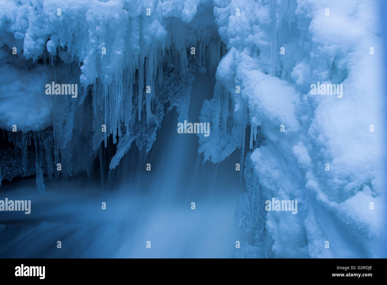 Frozen waterfall with blue ice in winter Stock Photo - Alamy
