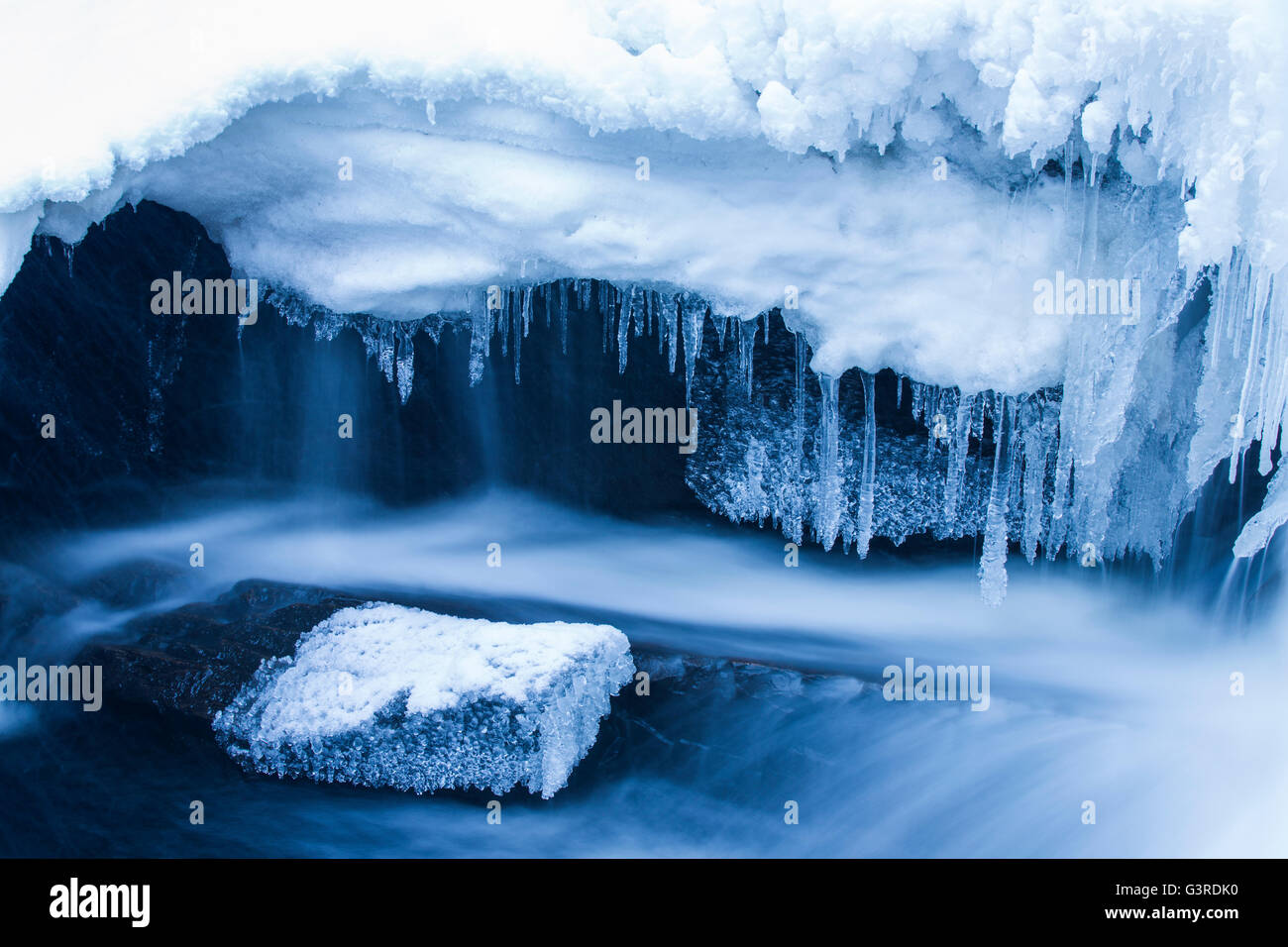 Frozen waterfall with blue ice in winter Stock Photo - Alamy