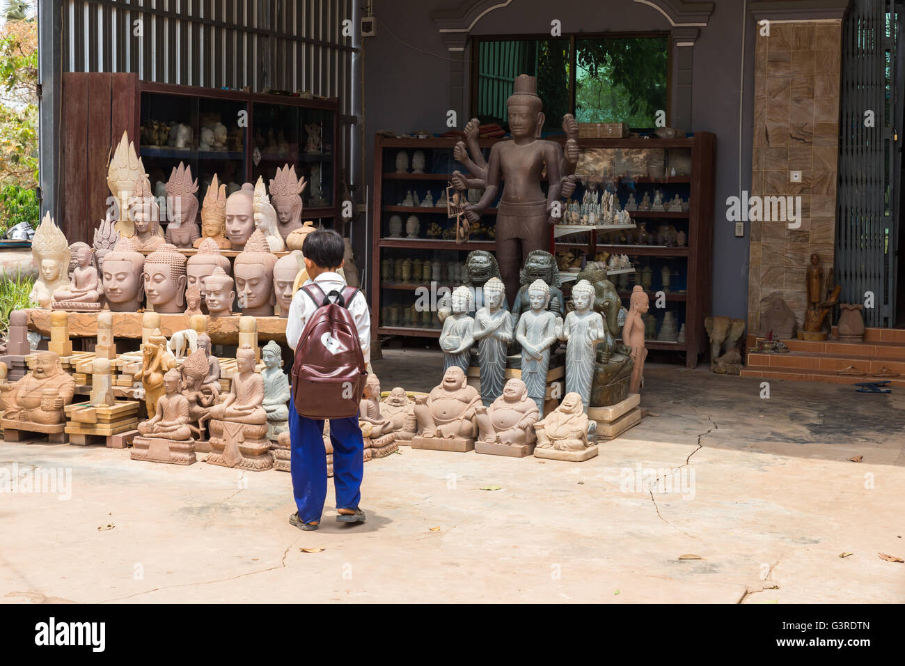 boy looks at statue of a Buddha Stock Photo - Alamy