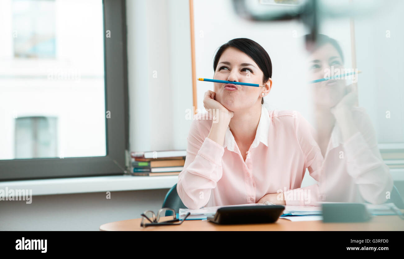 Young office worker dreaming in her workplace Stock Photo - Alamy
