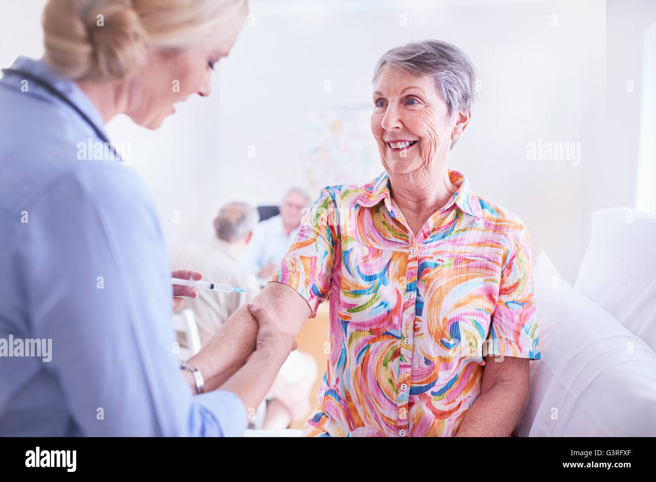 Doctor checking senior woman’s arm in checkup Stock Photo - Alamy