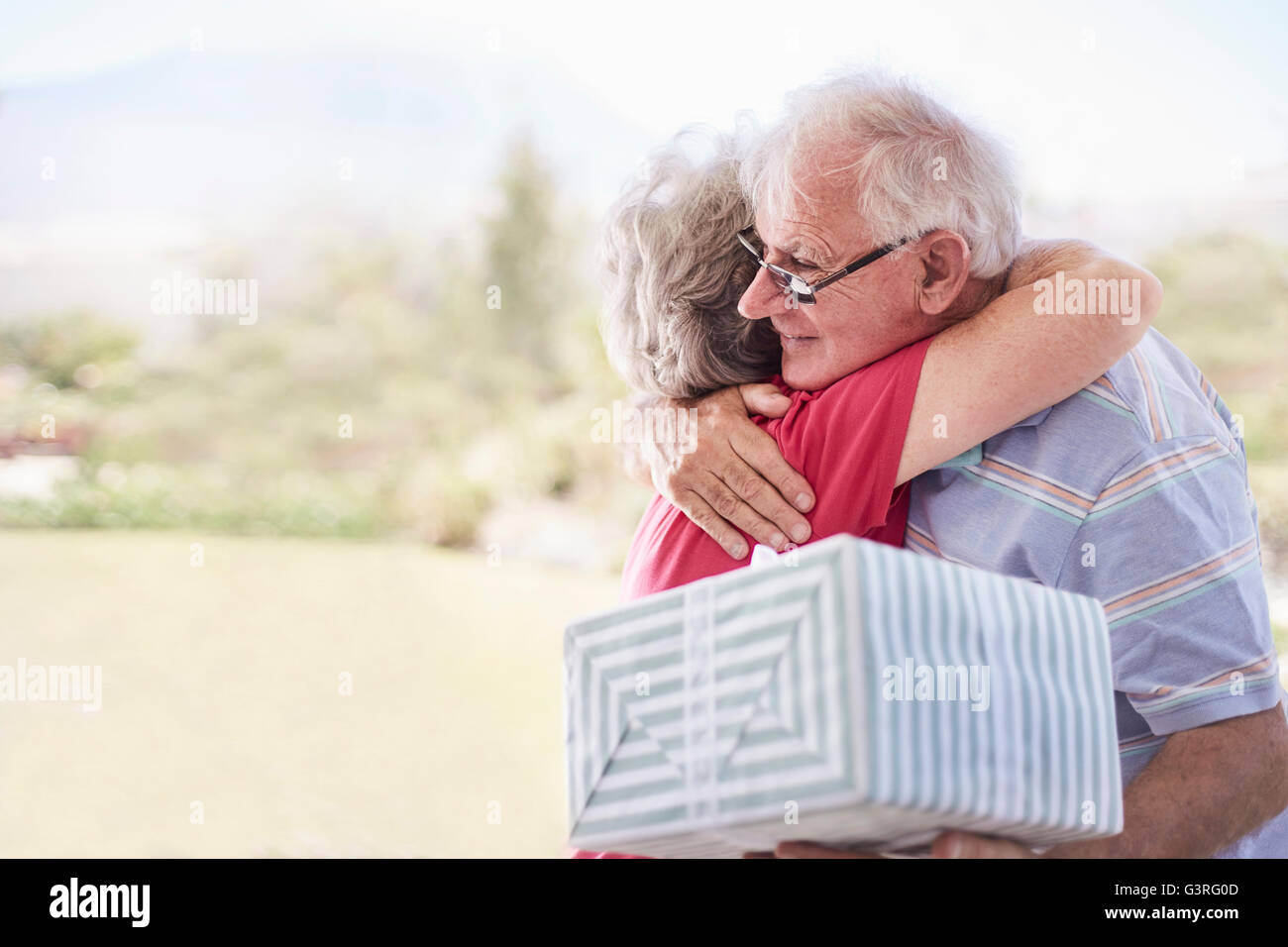 Senior couple hugging and celebrating birthday Stock Photo - Alamy