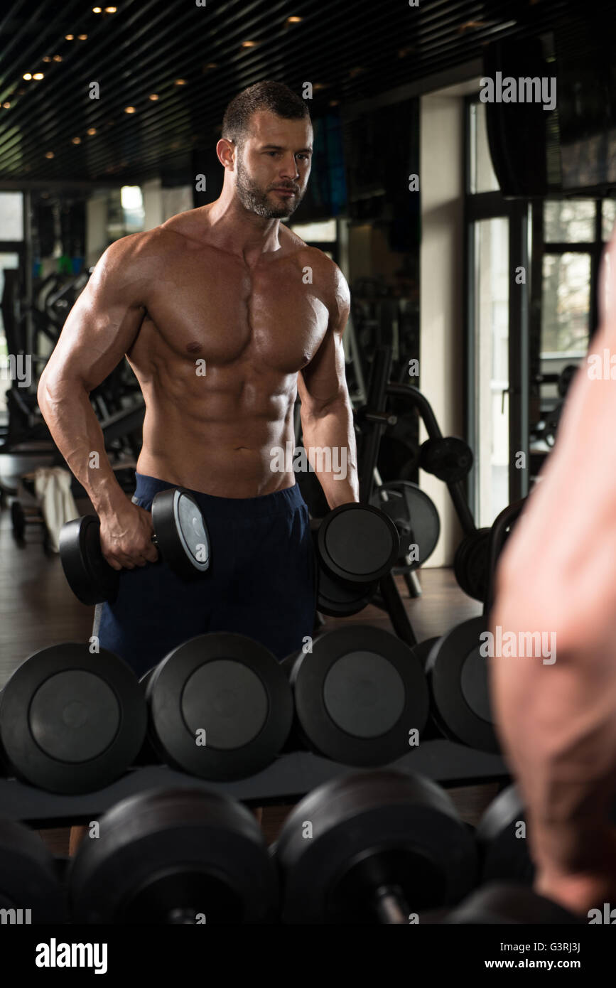 Portrait Of A Physically Fit Man Showing His Well Trained Body In Gym ...