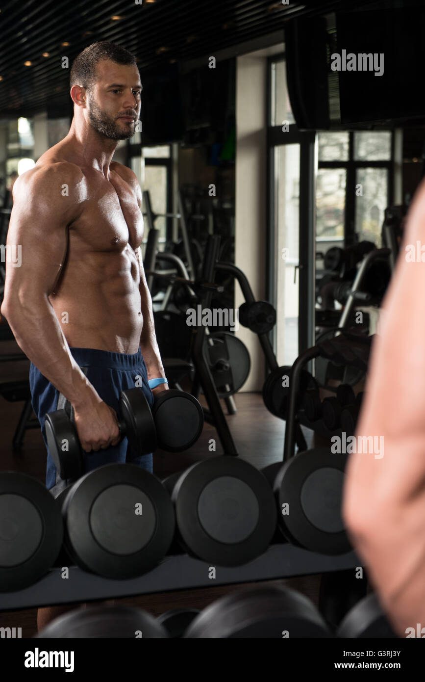 Portrait Of A Physically Fit Man Posing In Modern Fitness Center Gym ...