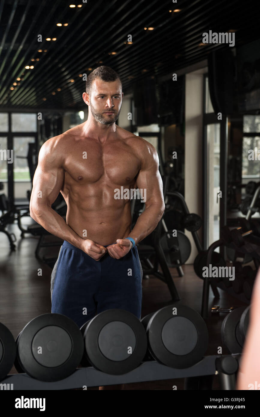 Portrait Of A Physically Fit Man Posing In Modern Fitness Center Gym ...