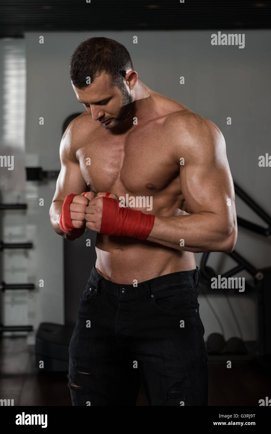 Portrait Of A Physically Fit Man Showing His Well Trained Body In Gym ...