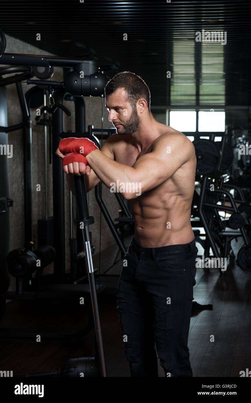Portrait Of A Physically Fit Man Showing His Well Trained Body In Gym ...