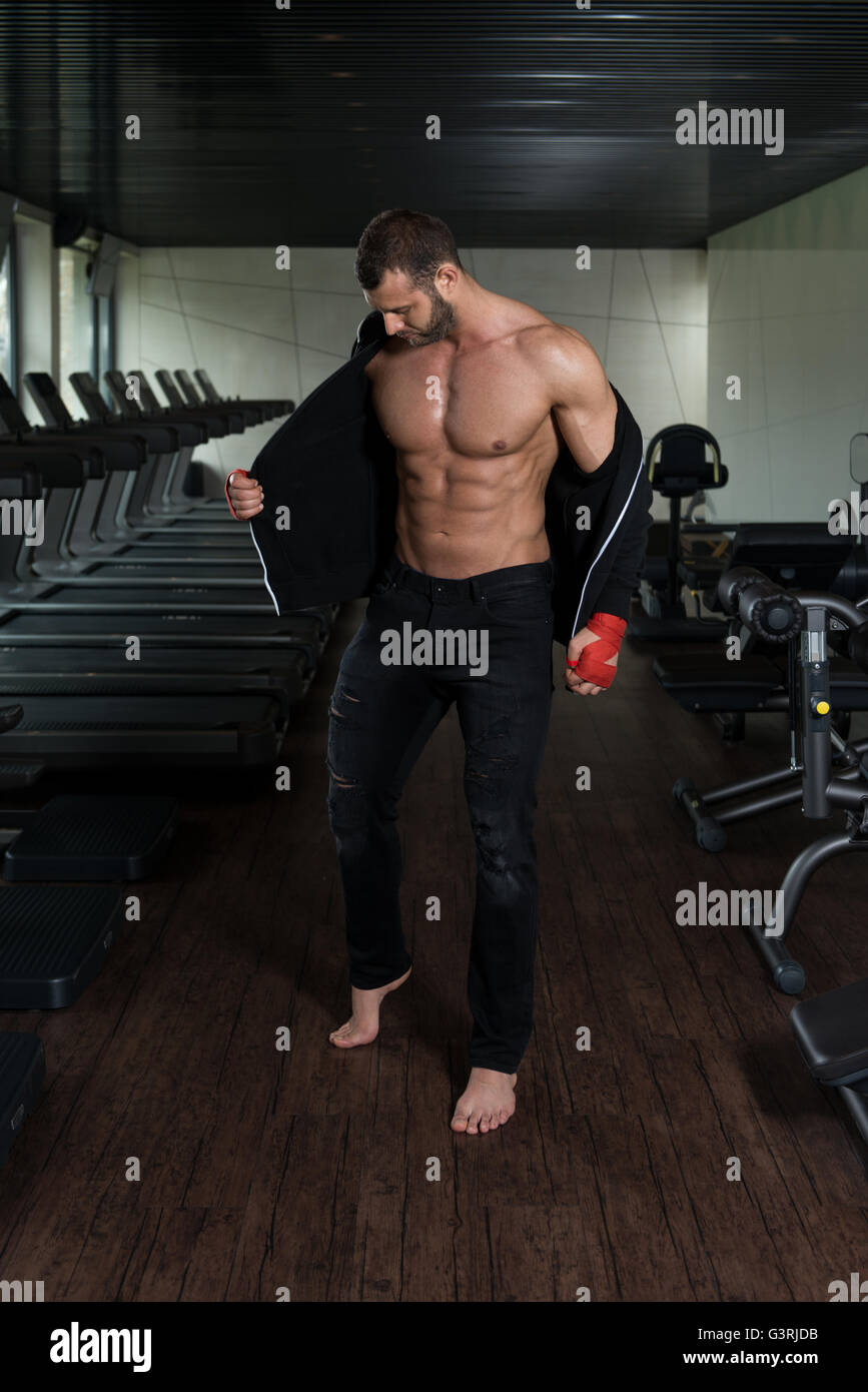 Portrait Of A Physically Fit Man Showing His Well Trained Body In Gym ...