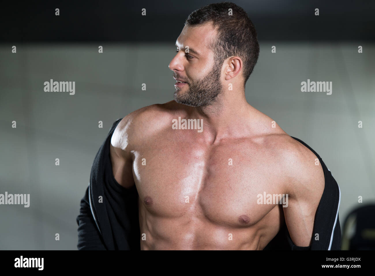 Portrait Of A Physically Fit Man Posing In Modern Fitness Center Gym ...