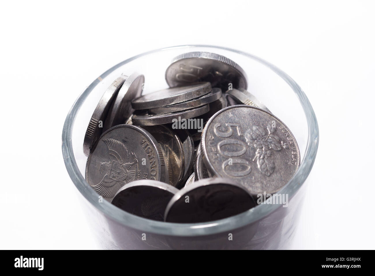 Stack of Coin Inside of Glass on white background Stock Photo - Alamy