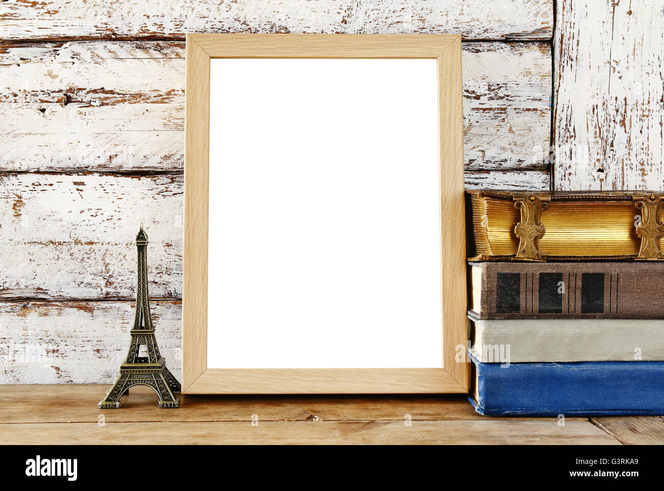 image of blank wooden frame, next to old books. template, ready to put ...