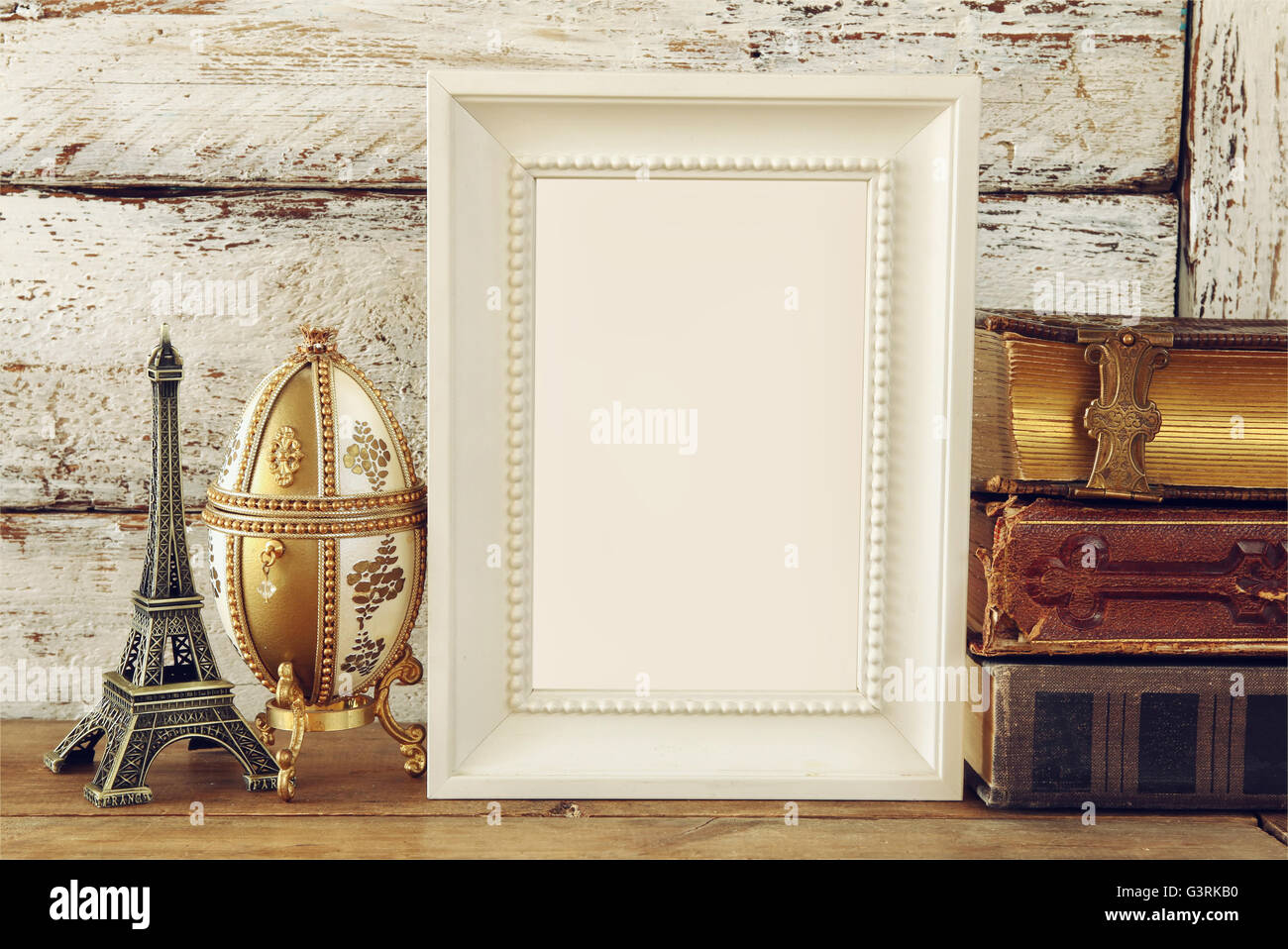 image of blank wooden frame, next to old books. template, ready to put ...