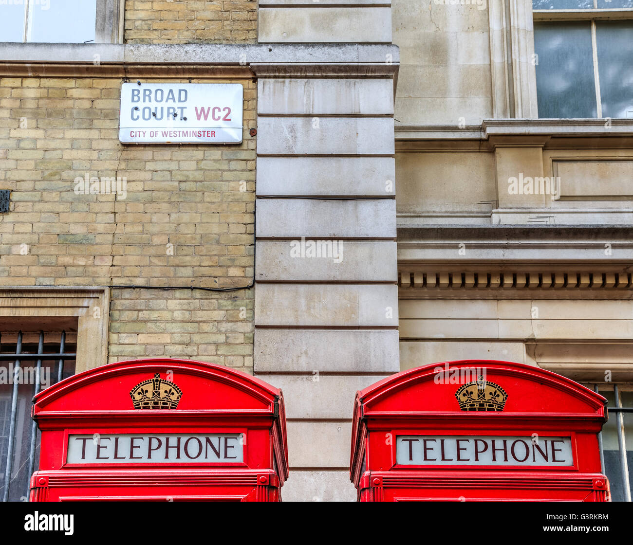 The iconic red telephone booths and street sign on Broad Court, Covent ...