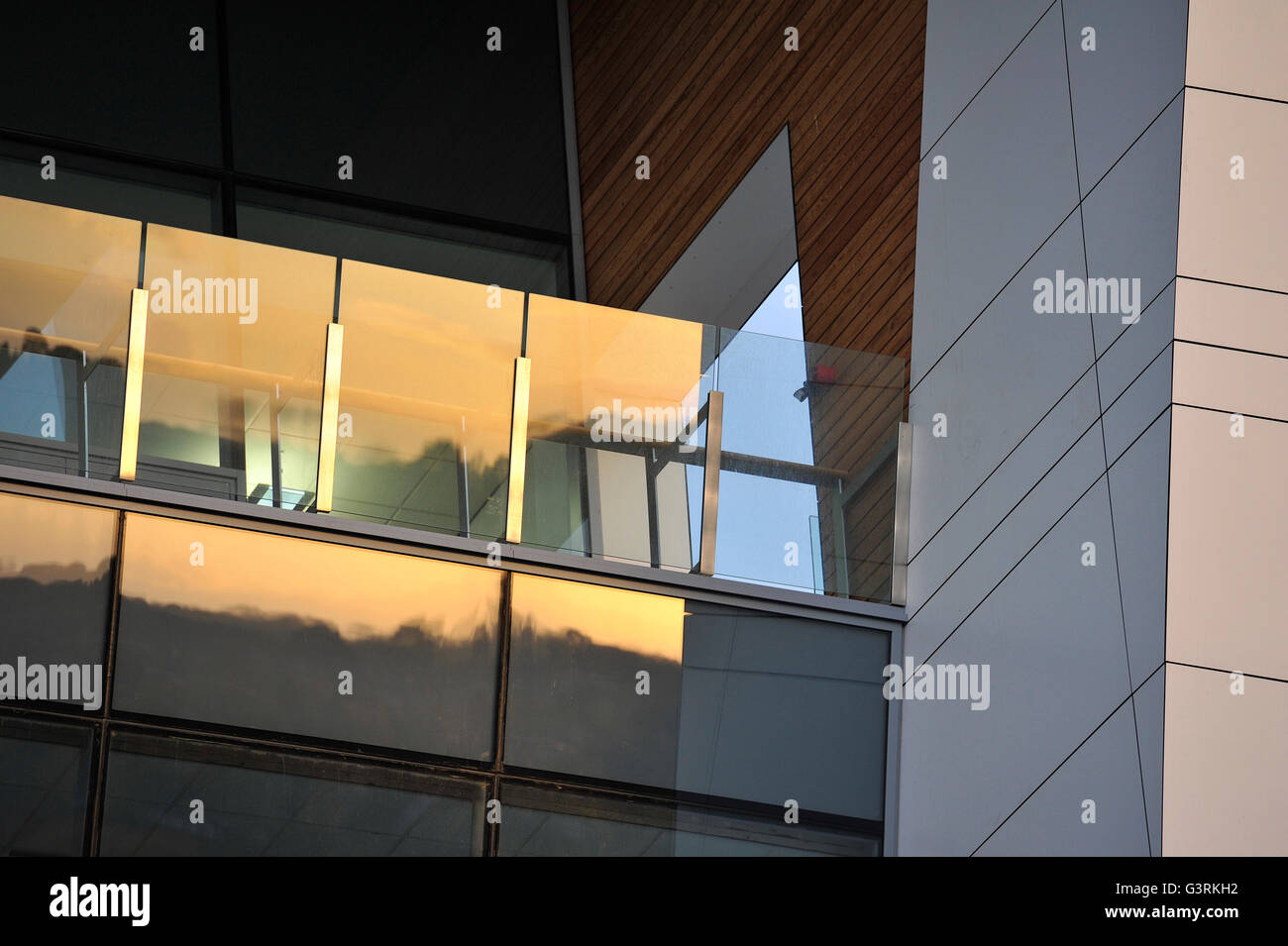 Architectural detail of exterior view of glass fronted balcony bathed ...
