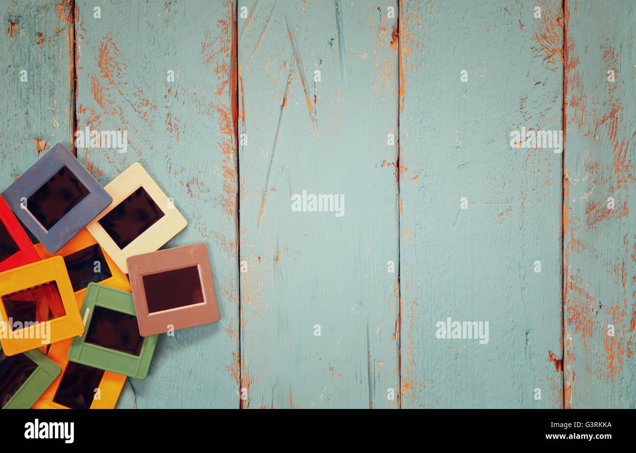 top view of old slides frames over wooden blue background. vintage ...