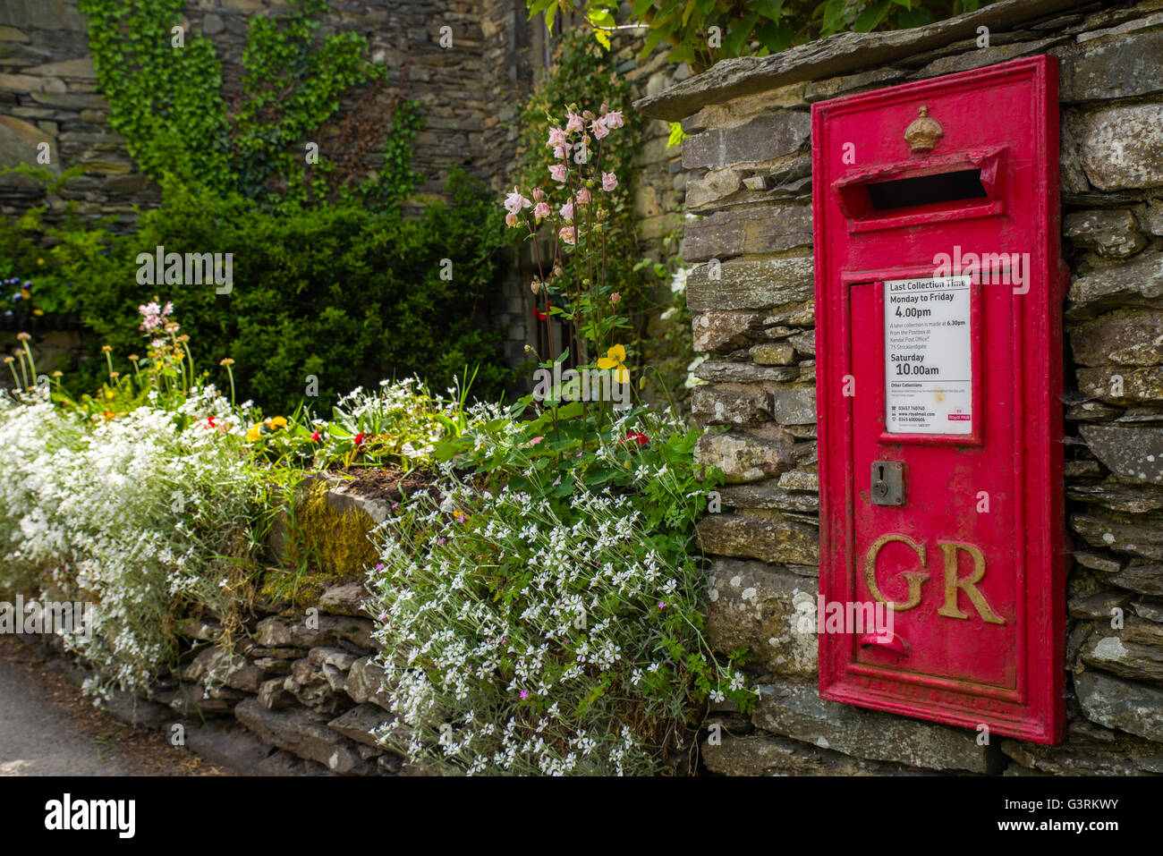 An old-fashioned post box in a traditional English countryside village ...