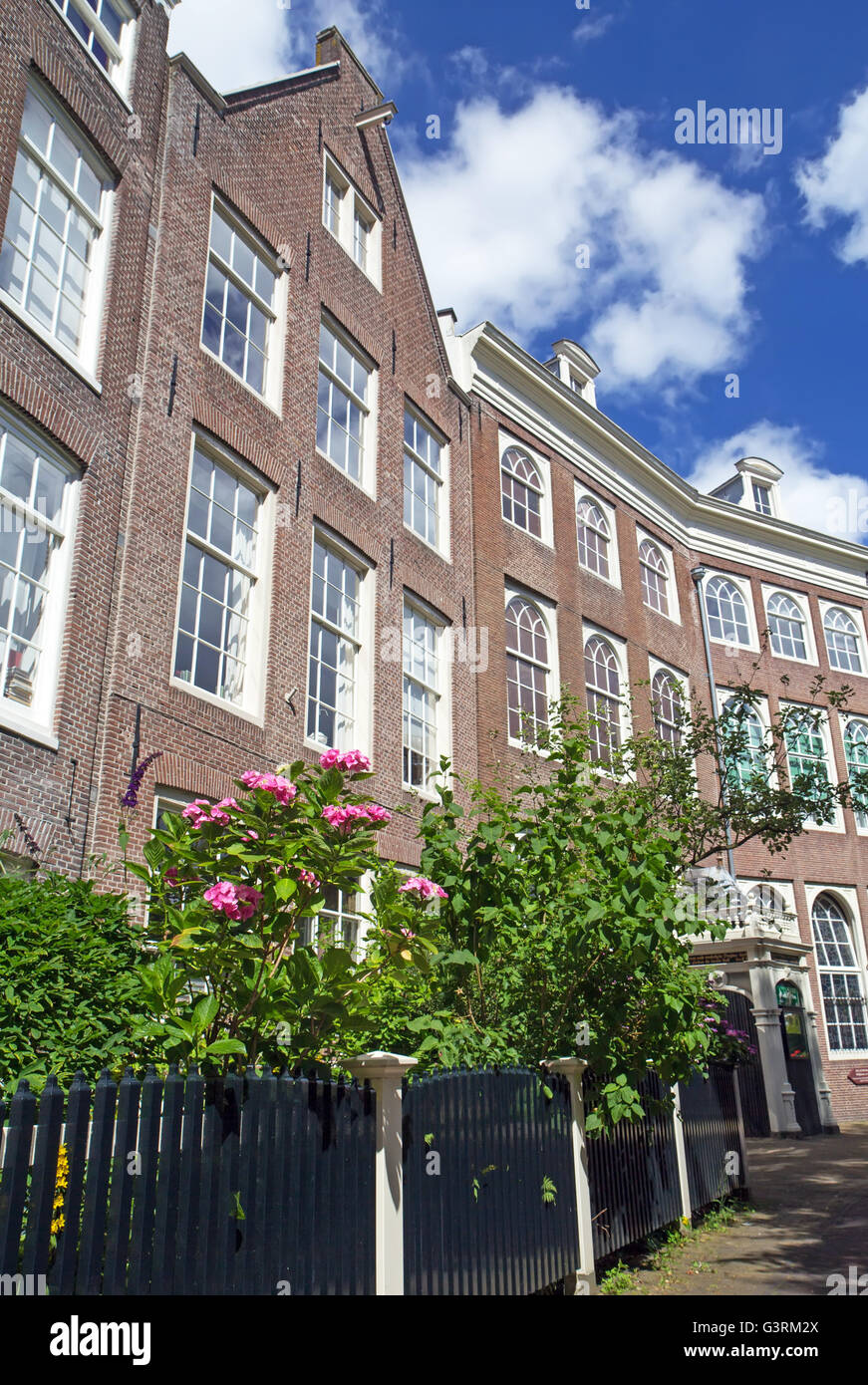 Typical Dutch houses in Amsterdam. Blue sky with clouds in the ...