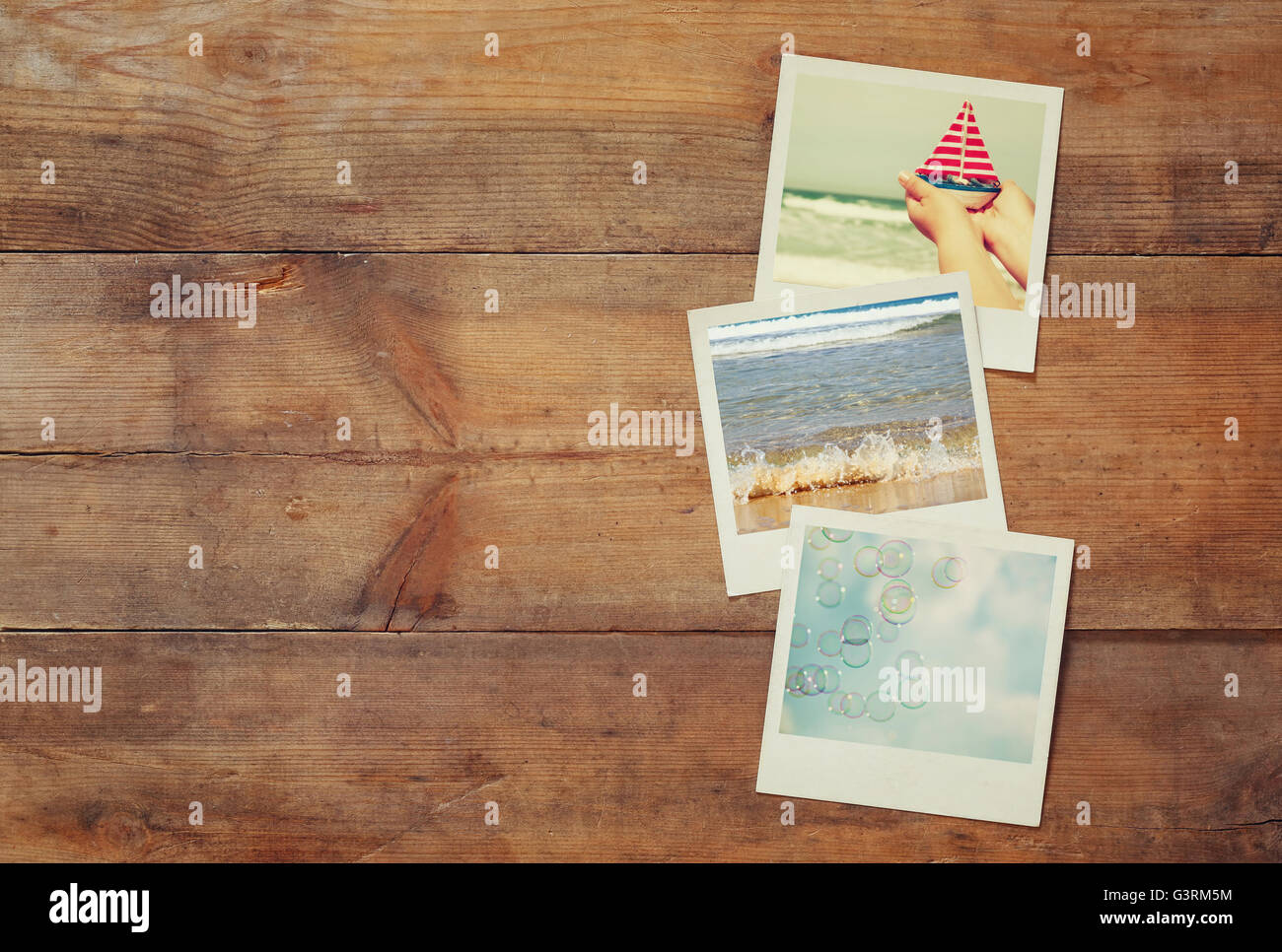 top view of instant polaroid photos album on wooden background. vintage ...