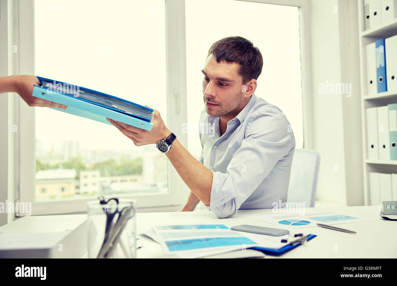 businessman taking papers from secretary in office Stock Photo - Alamy