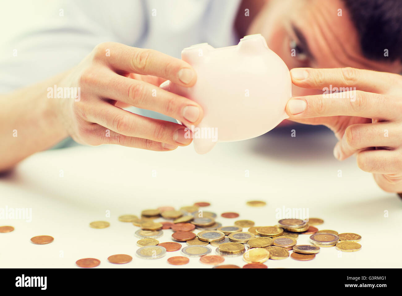 Man shaking piggy bank hi-res stock photography and images - Alamy
