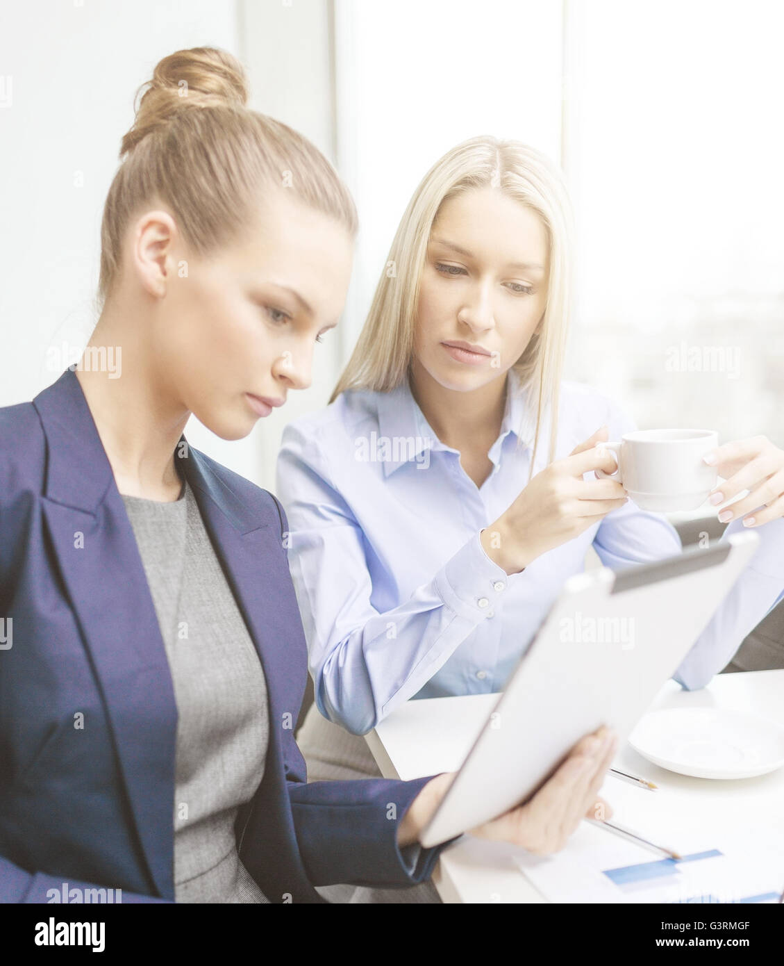 business team with tablet pc having discussion Stock Photo - Alamy