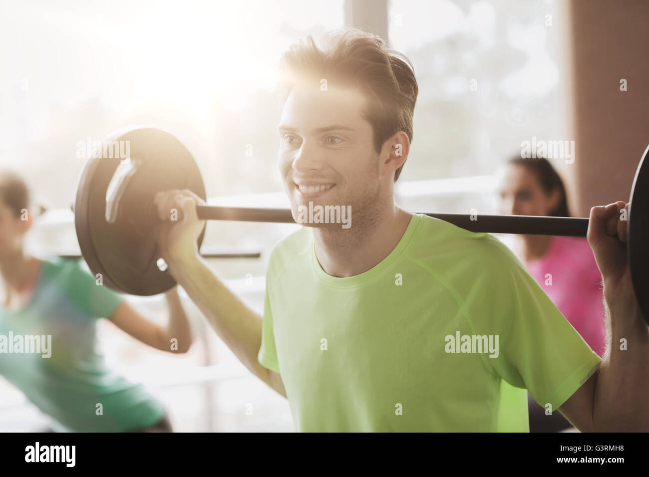 group of people exercising with barbell in gym Stock Photo - Alamy