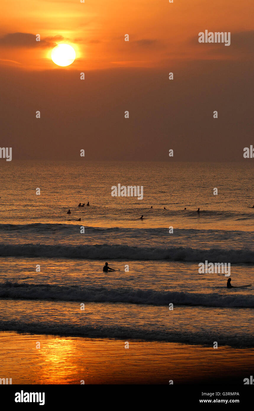 Surfers at Sunset Stock Photo - Alamy