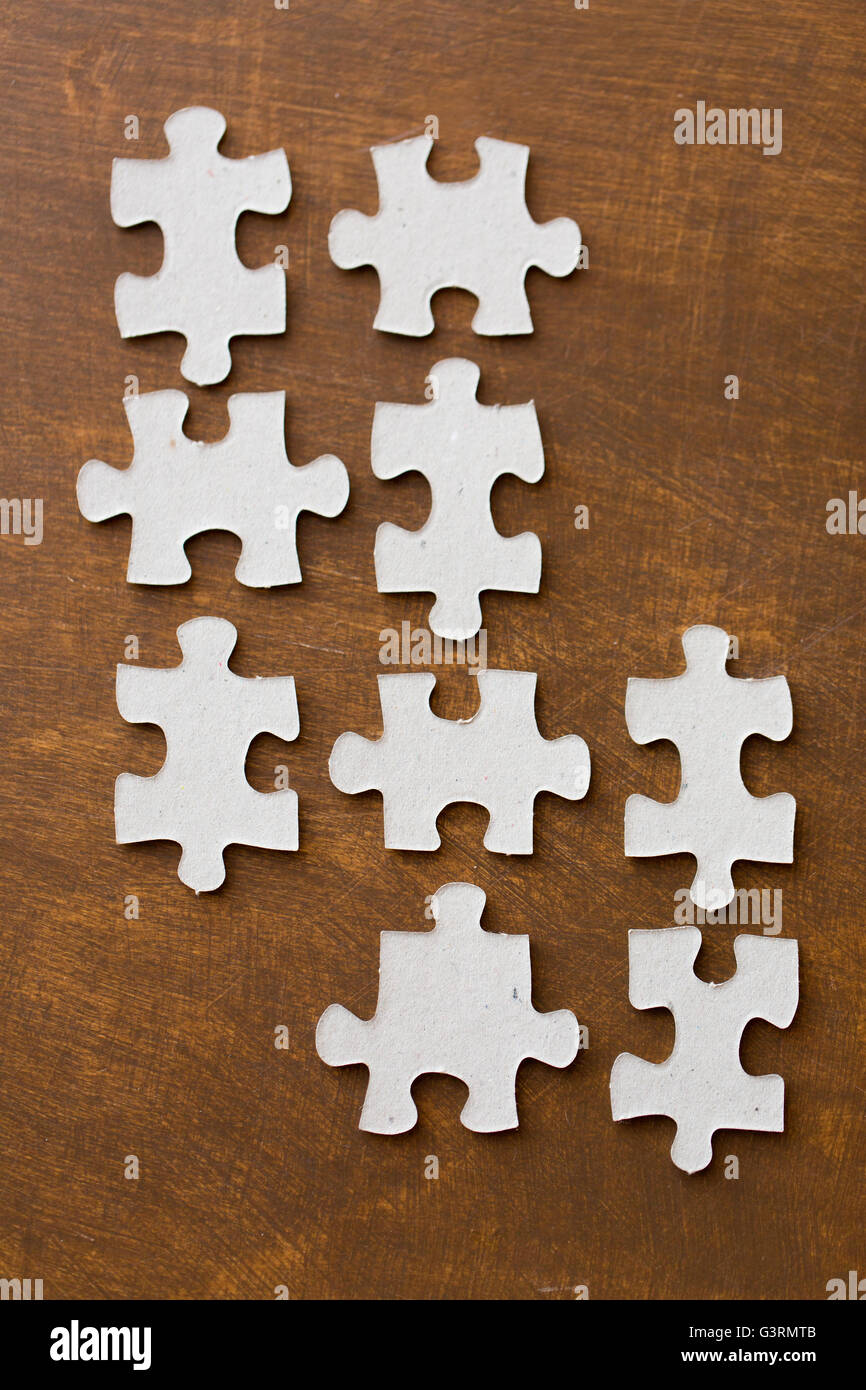 close up of puzzle pieces on wooden surface Stock Photo - Alamy