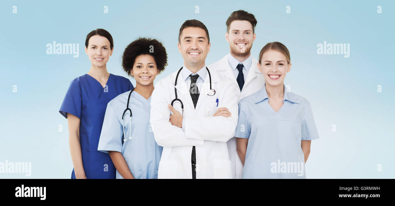 group of happy doctors over blue background Stock Photo - Alamy