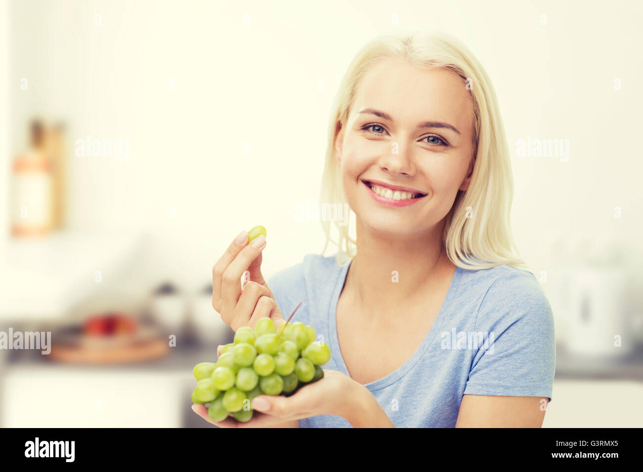 Woman eating grapes hi-res stock photography and images - Alamy