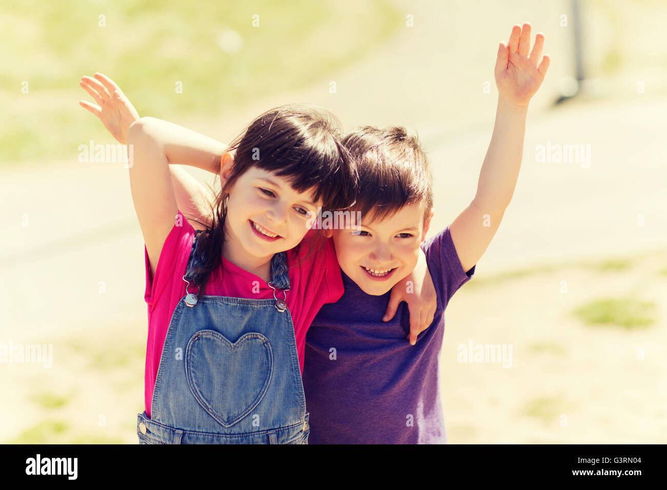 two happy kids hugging outdoors Stock Photo - Alamy