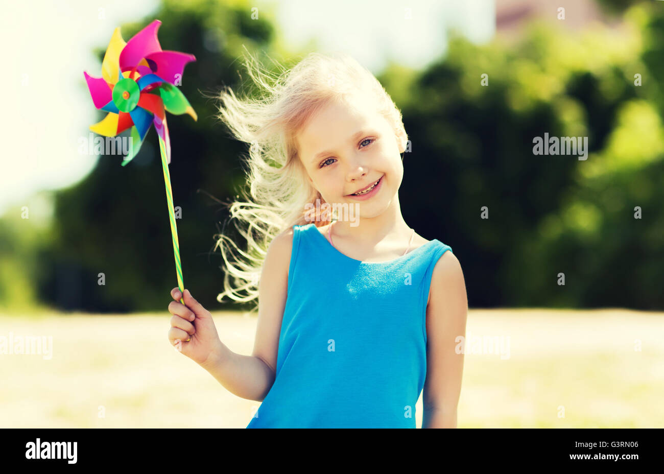 happy little girl with colorful pinwheel at summer Stock Photo - Alamy
