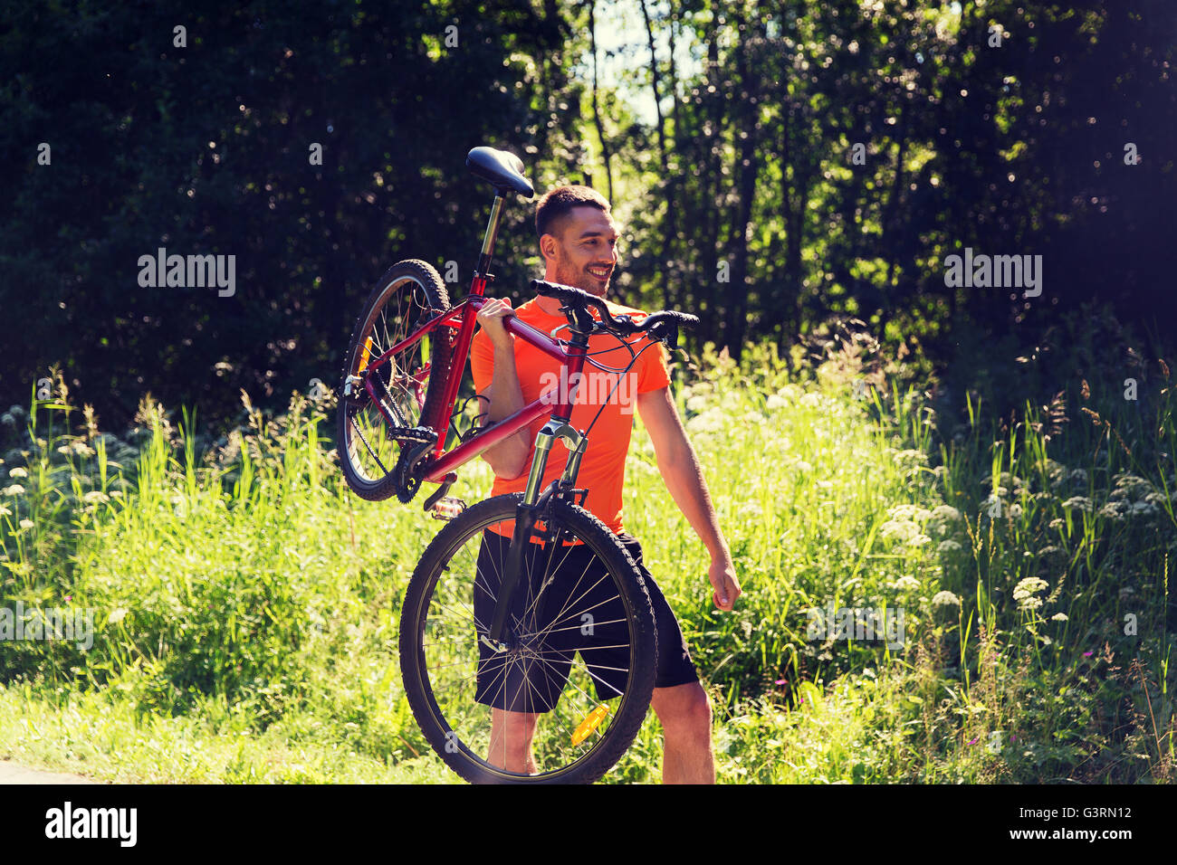 happy young man riding bicycle outdoors Stock Photo - Alamy