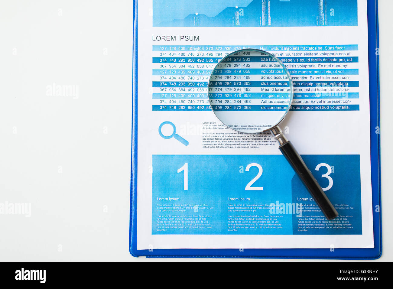 close up of financial report and magnifying glass Stock Photo - Alamy
