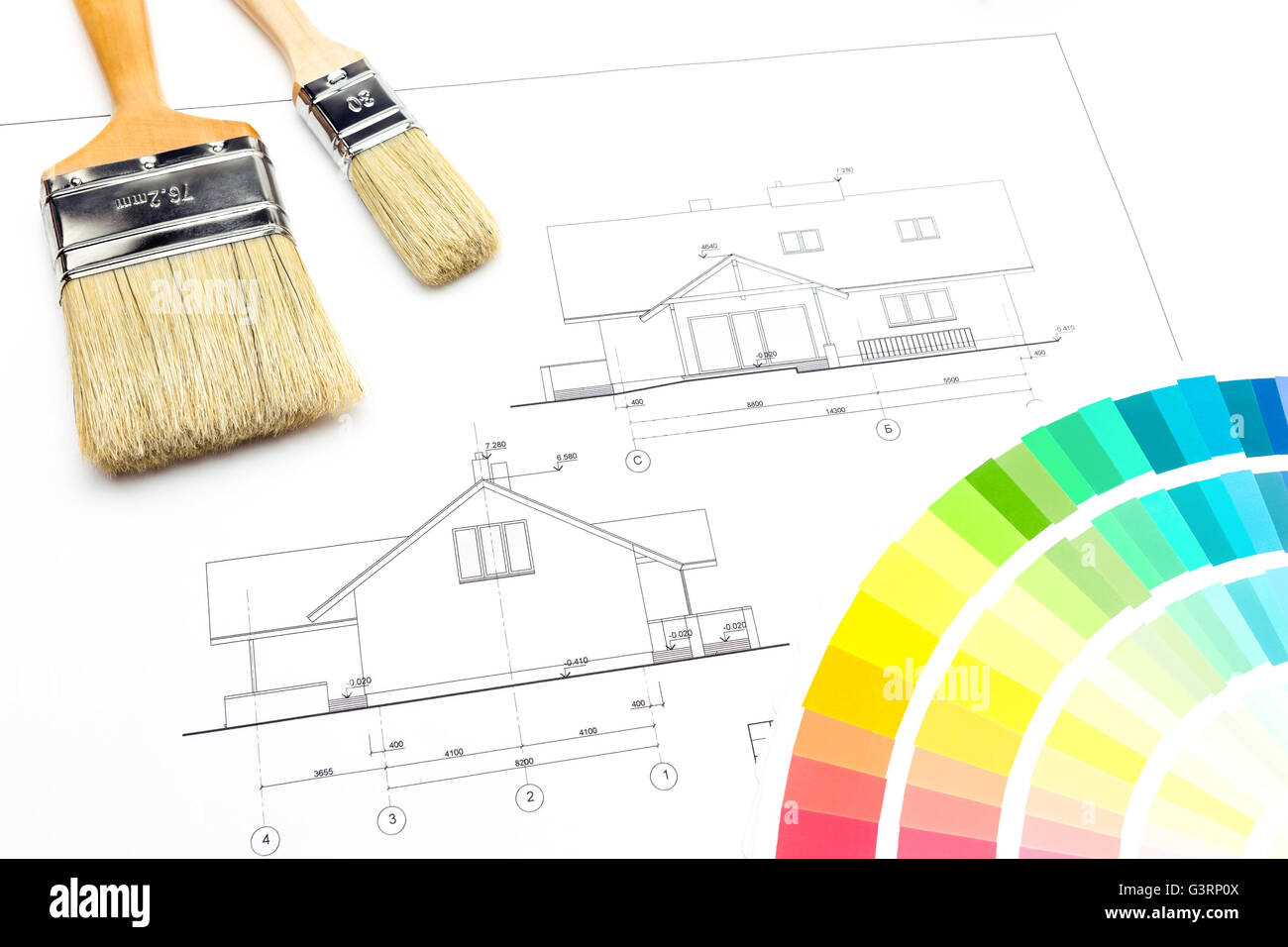 Architect's workplace with house blueprints, color samples and brushes ...