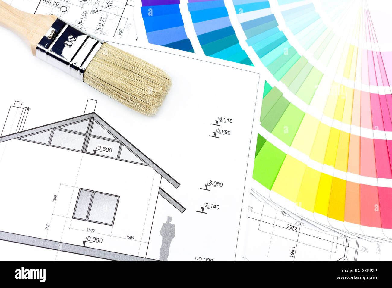 Architect's workplace with house blueprints, color samples and brushes ...