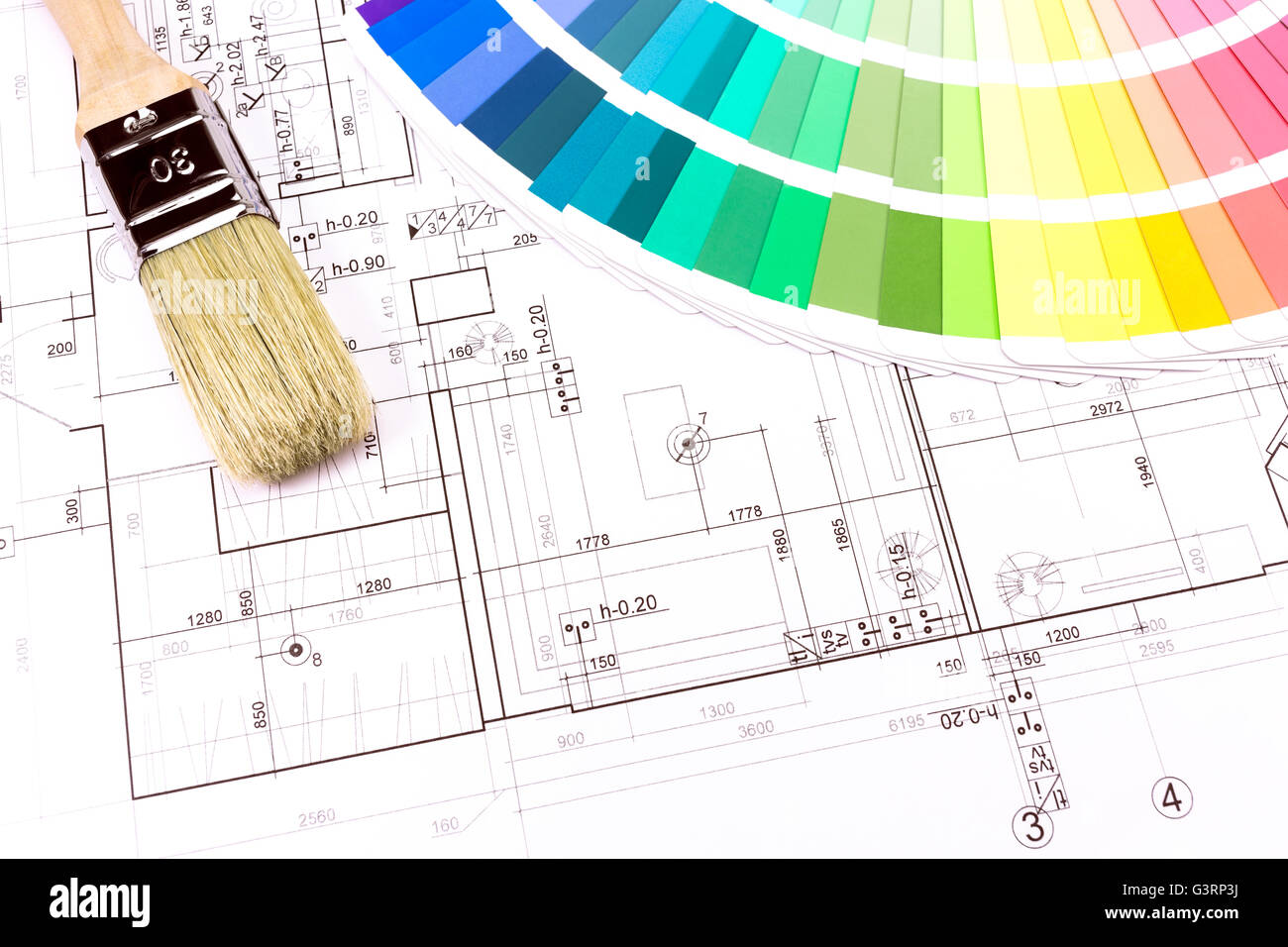 Architect's workplace with house blueprints, color samples and brushes ...